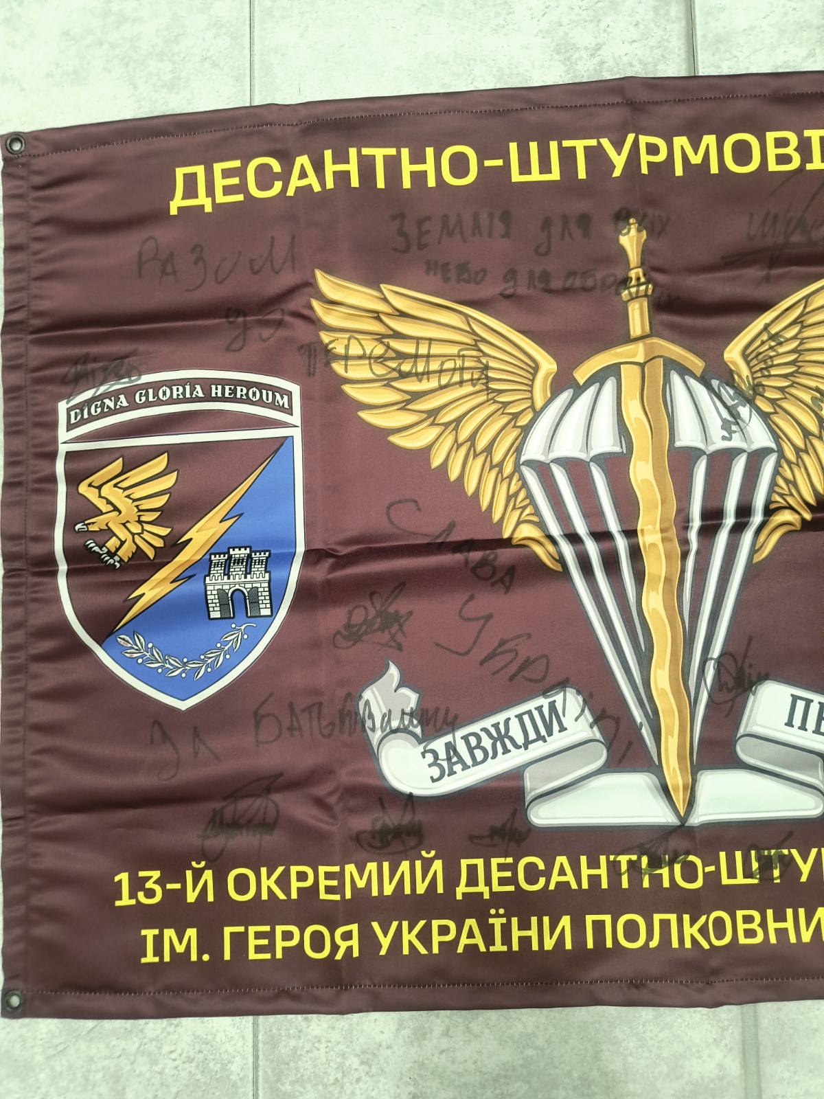 Ukrainian flag signed by fighters of 95th Air Assault Brigade with ...